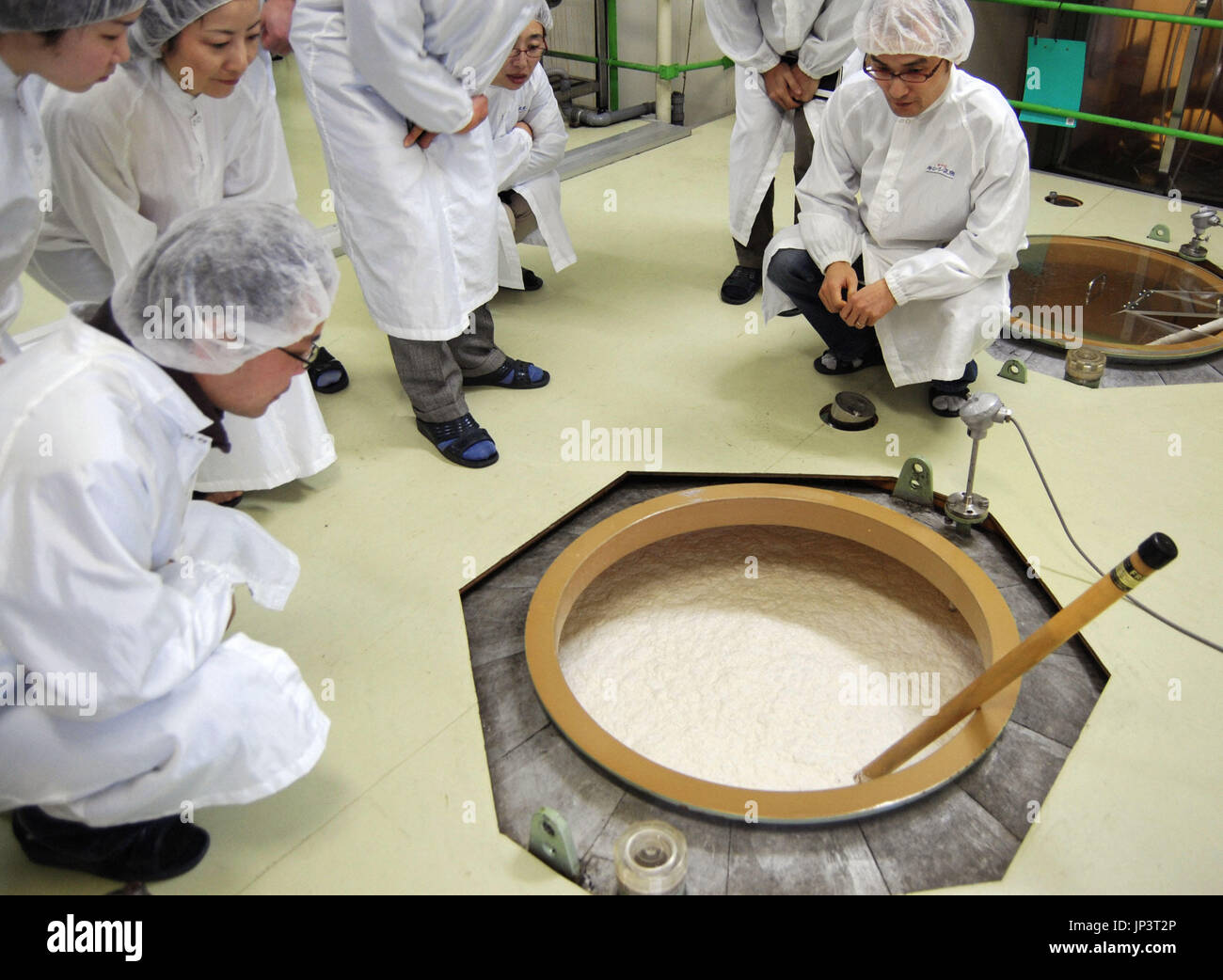 OSAKA, Japan - Visitors on a guided tour at Japanese sake brewer Kinshi ...