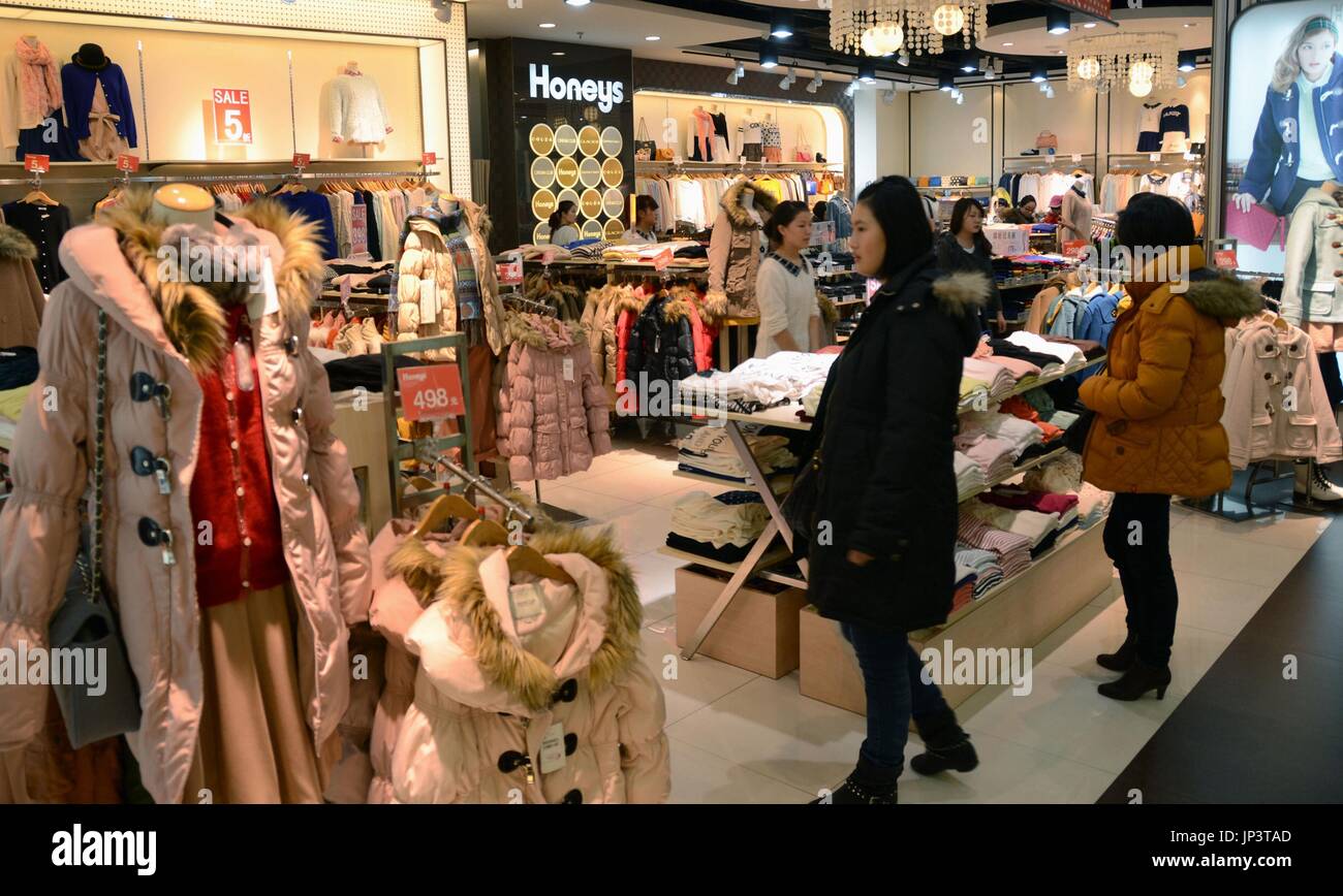 SHANGHAI, China - Visitors shop at a clothing store in Shanghai, China ...