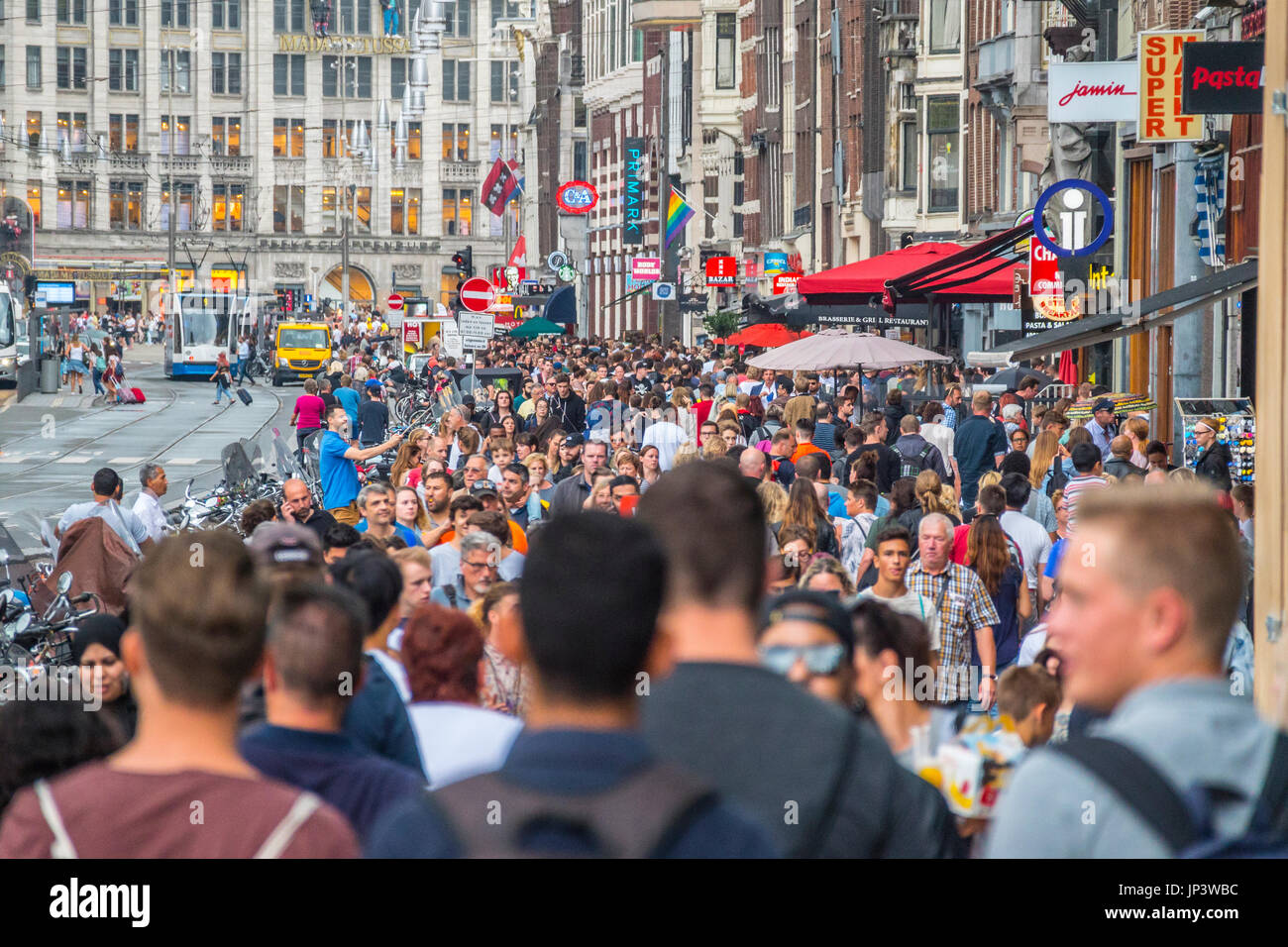 Huge crowd of tourists at famous Damrak street in Amsterdam - AMSTERDAM ...