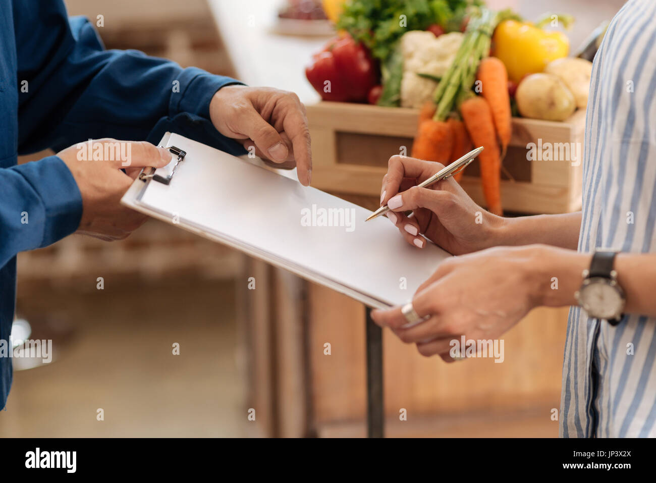 Wonderful clever client writing down her name Stock Photo - Alamy