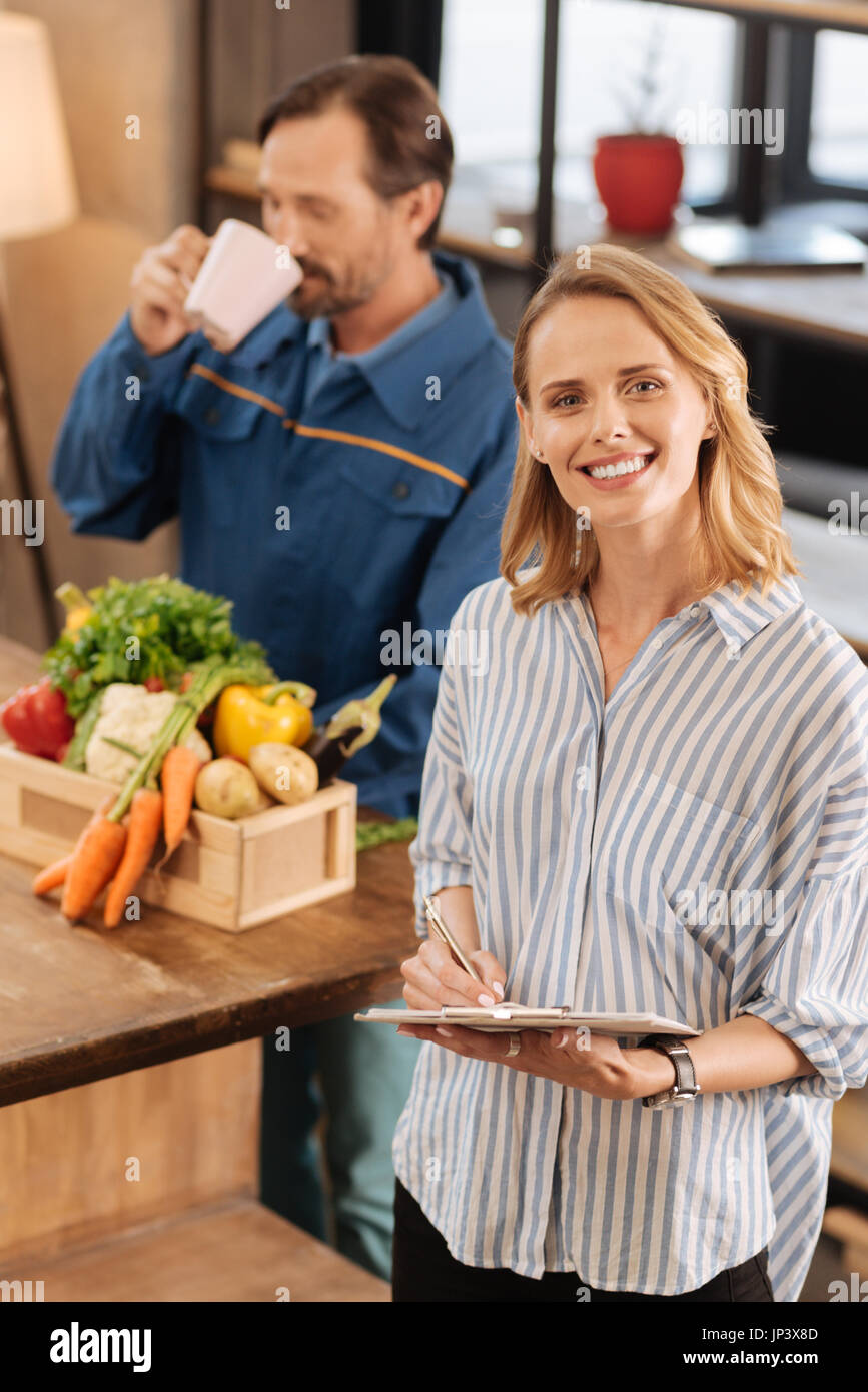 Stunning sincere woman offering courier some tea Stock Photo - Alamy