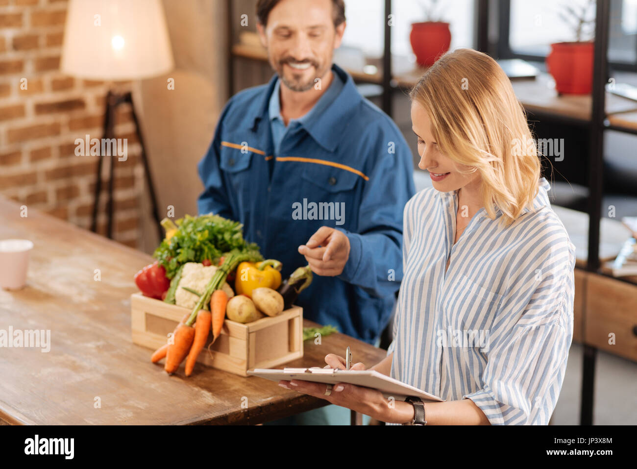 Intelligent pretty woman looking thought the document Stock Photo - Alamy