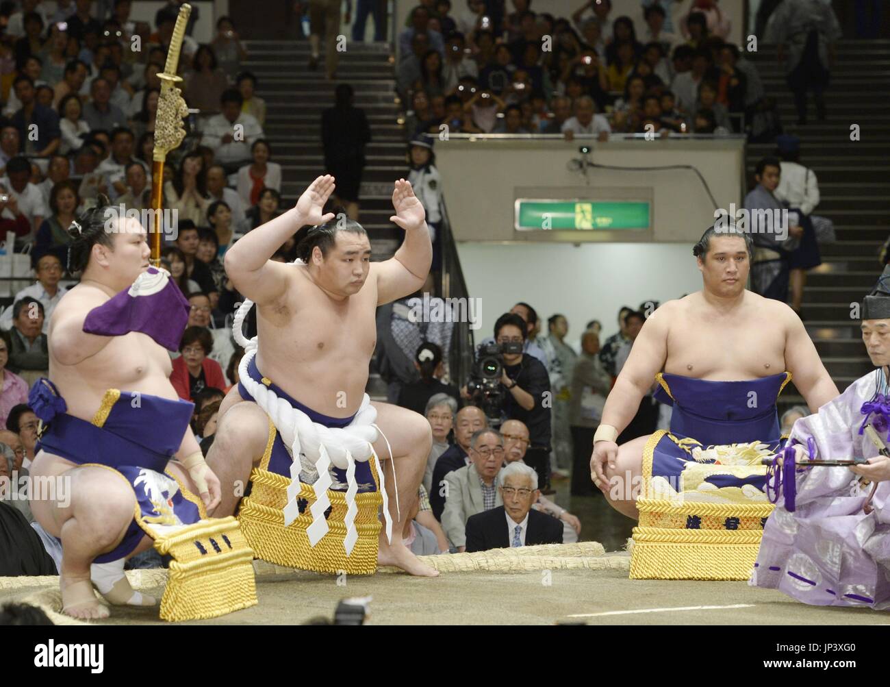TOKYO, Japan - New yokozuna Kakuryu (C) performs a traditional ring ...