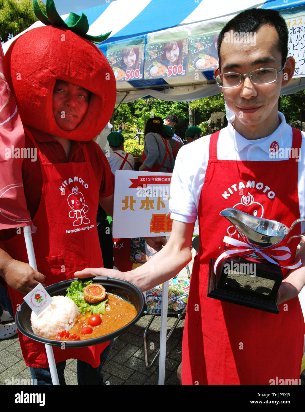 YOKOSUKA, Japan - Food vendor staffers hold a tomato curry from ...