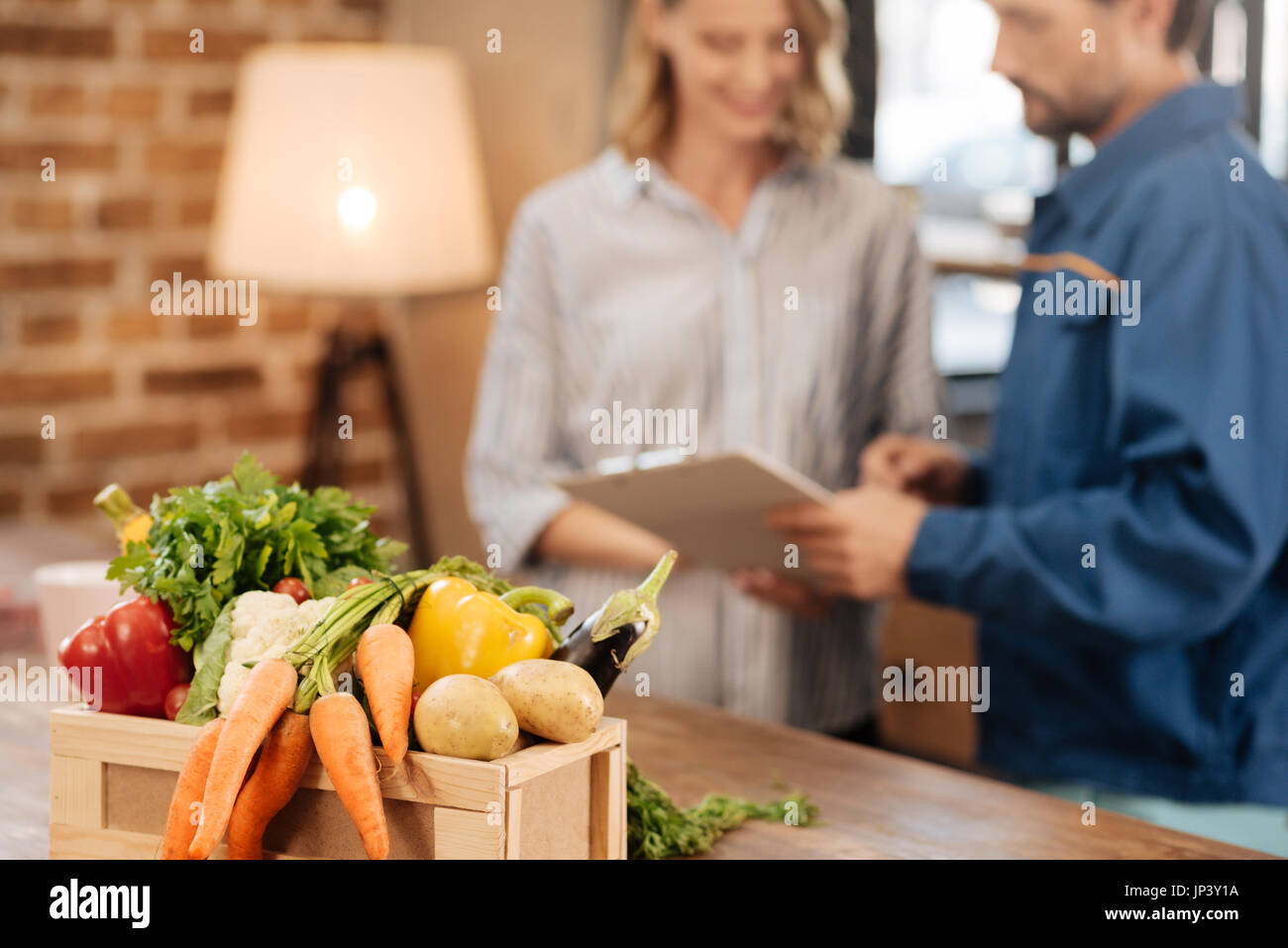 Charming polite guy delivering high quality products Stock Photo - Alamy