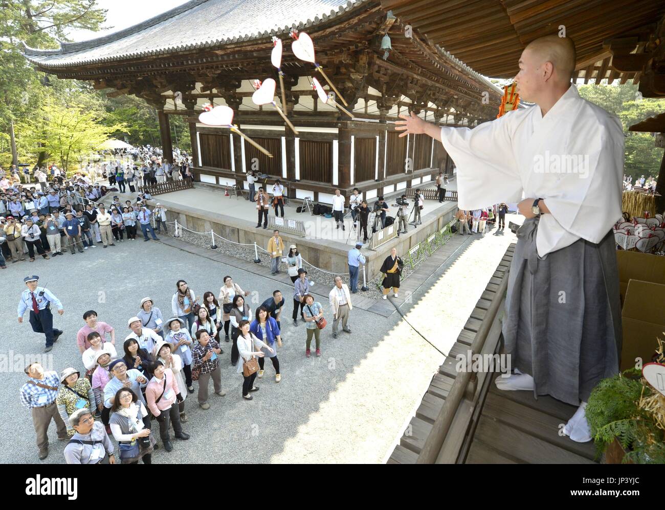 NARA, Japan - A monk throws heart-shaped paper fans, believed to drive ...