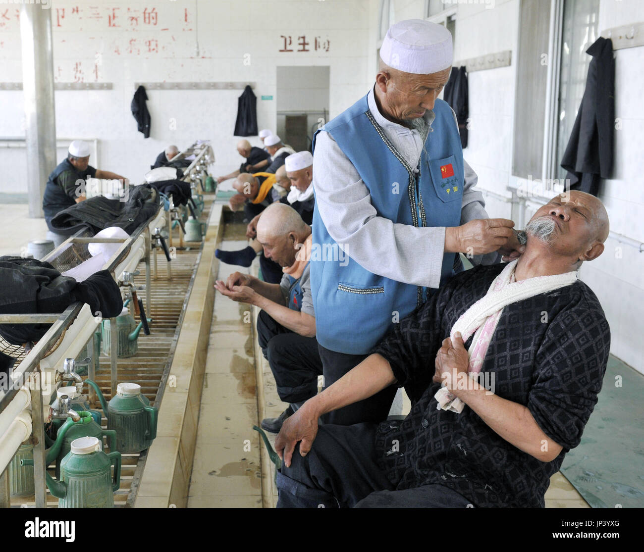 BEIJING, China - A man gets a shave before prayers at a mosque in ...