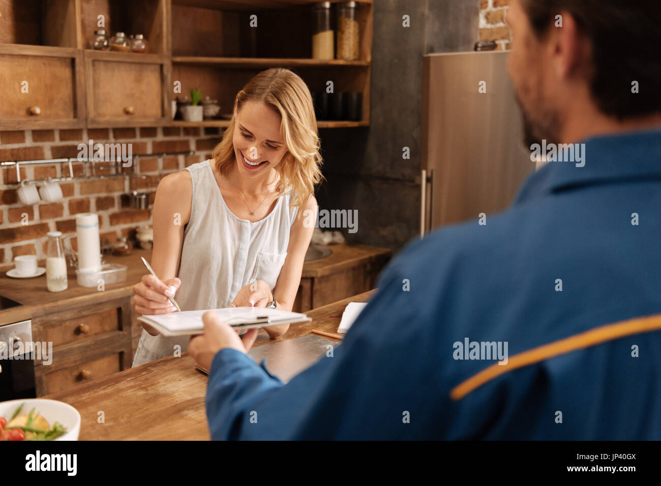 Bright intelligent lady writing her name on a document Stock Photo - Alamy