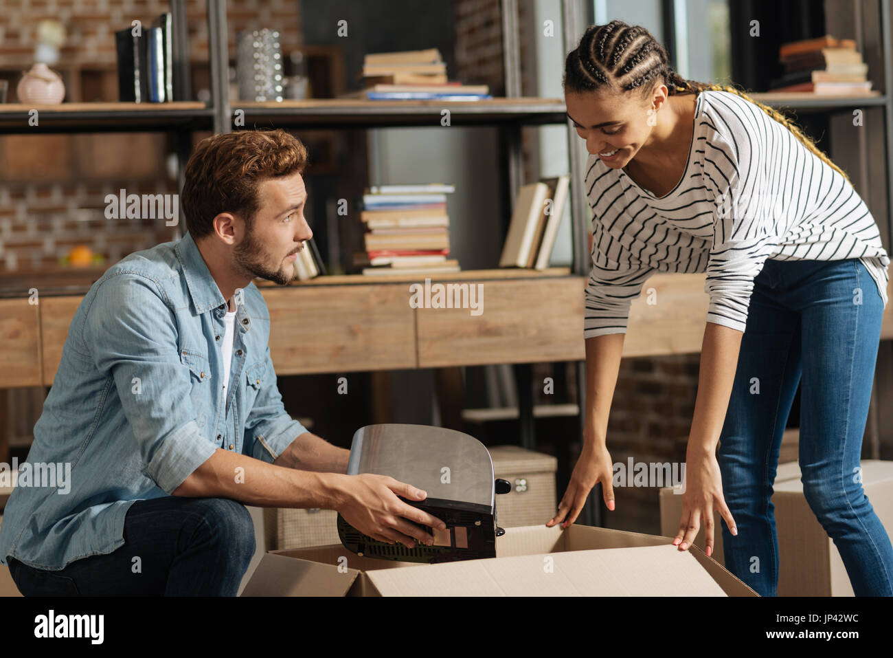 Positive delighted couple talking to each other Stock Photo - Alamy