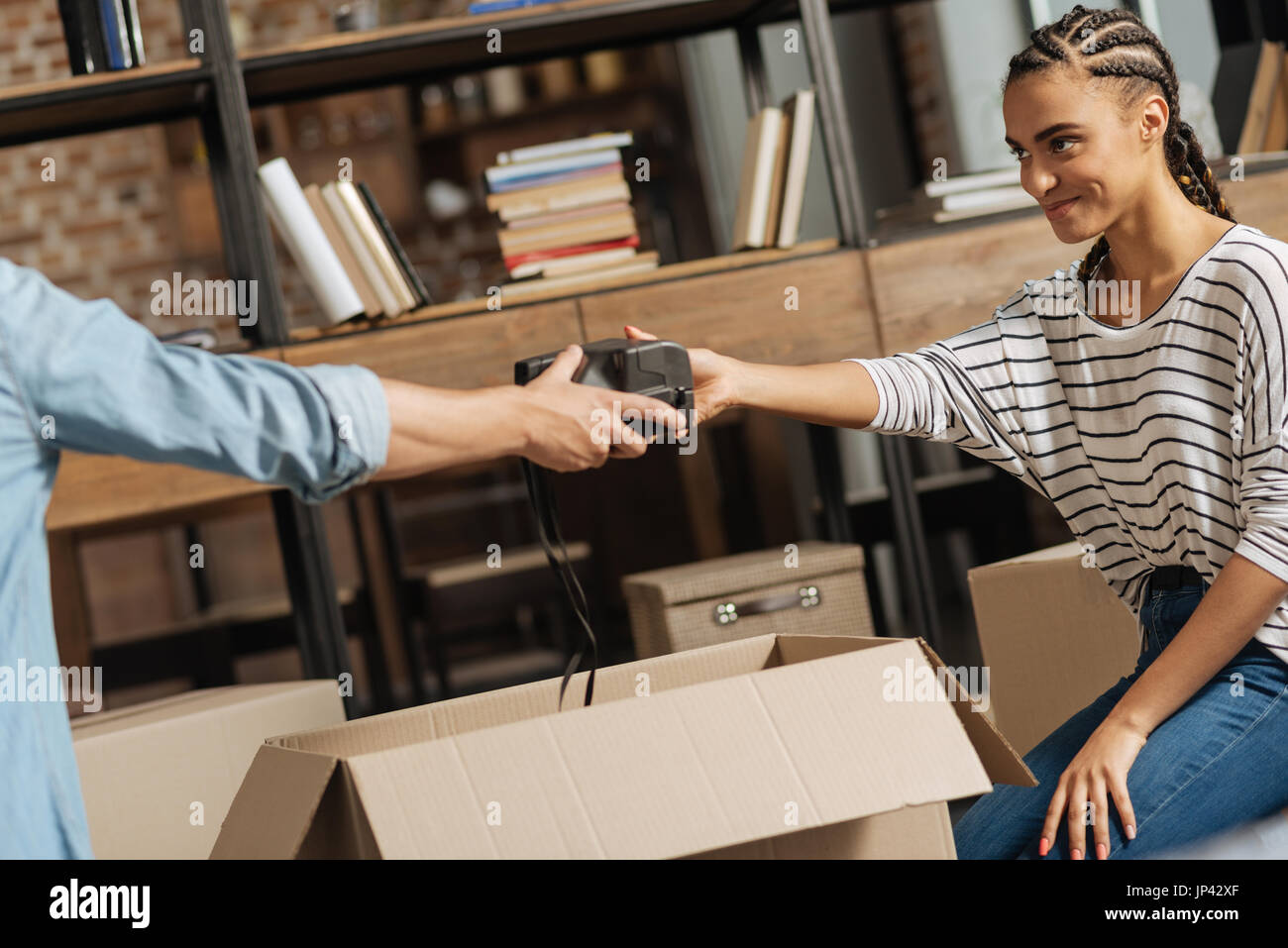 Busy male person giving his camera to girlfriend Stock Photo - Alamy