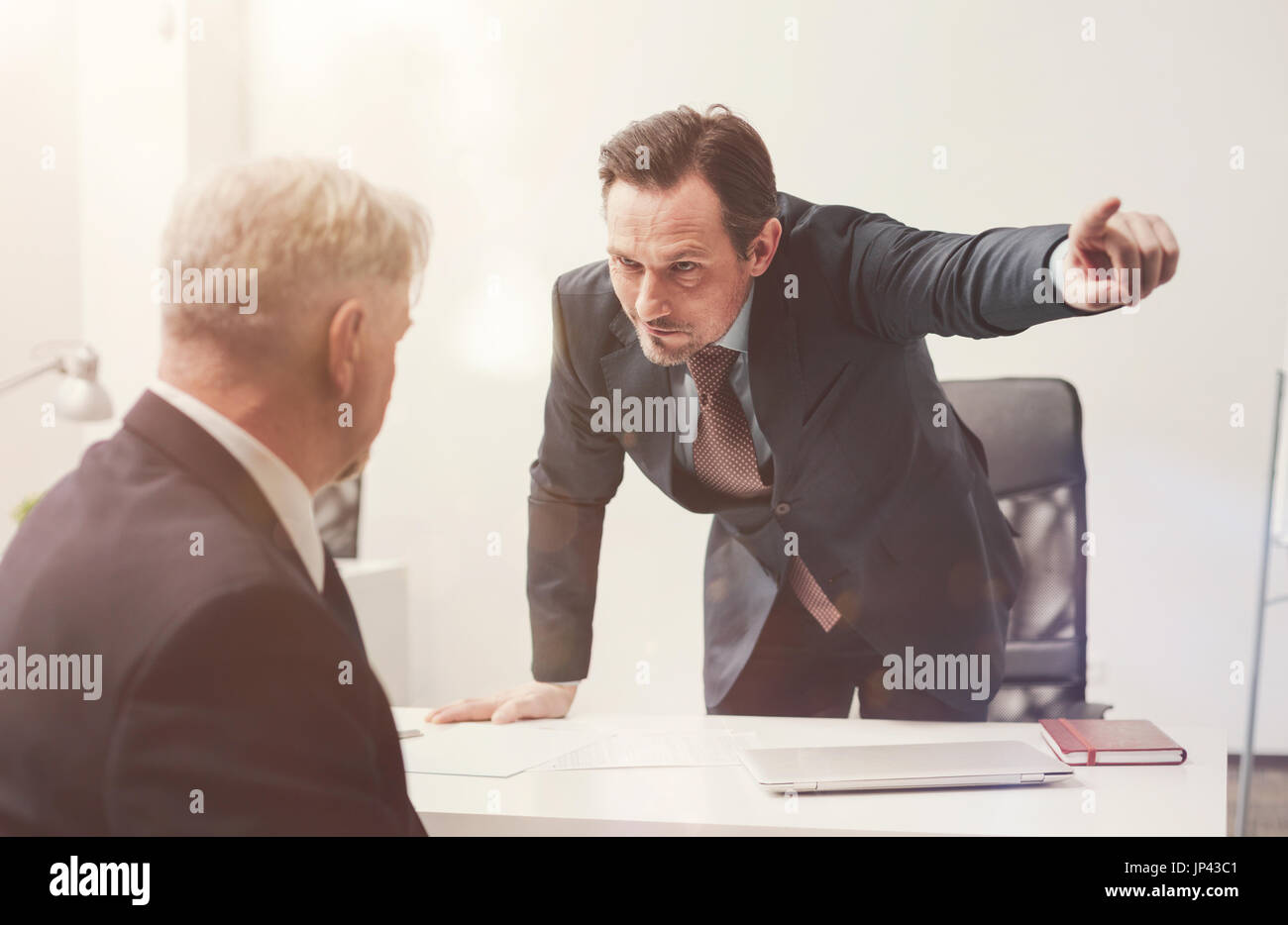 Impulsive stressed executive firing his employee Stock Photo - Alamy