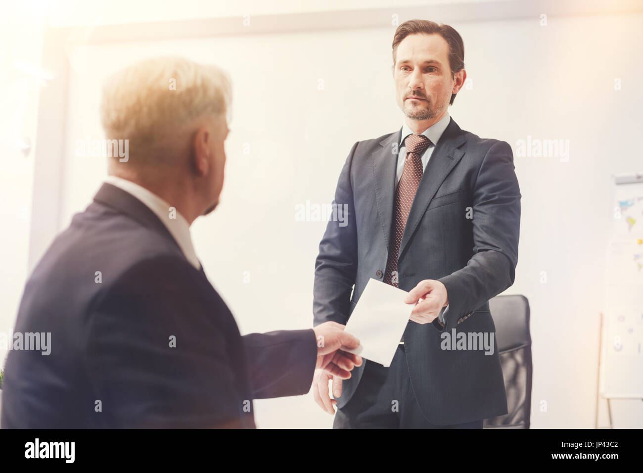 Determined ambitious man submitting his letter of resignation Stock ...