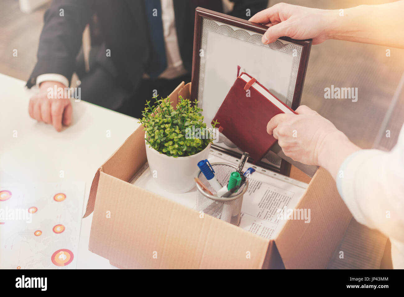 Businessman packing up box in office hi-res stock photography and ...