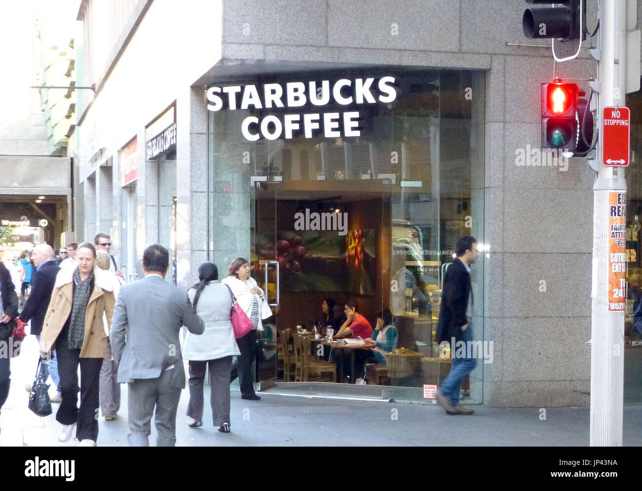 SYDNEY, Australia - People walk by a Starbucks Coffee shop in Sydney ...