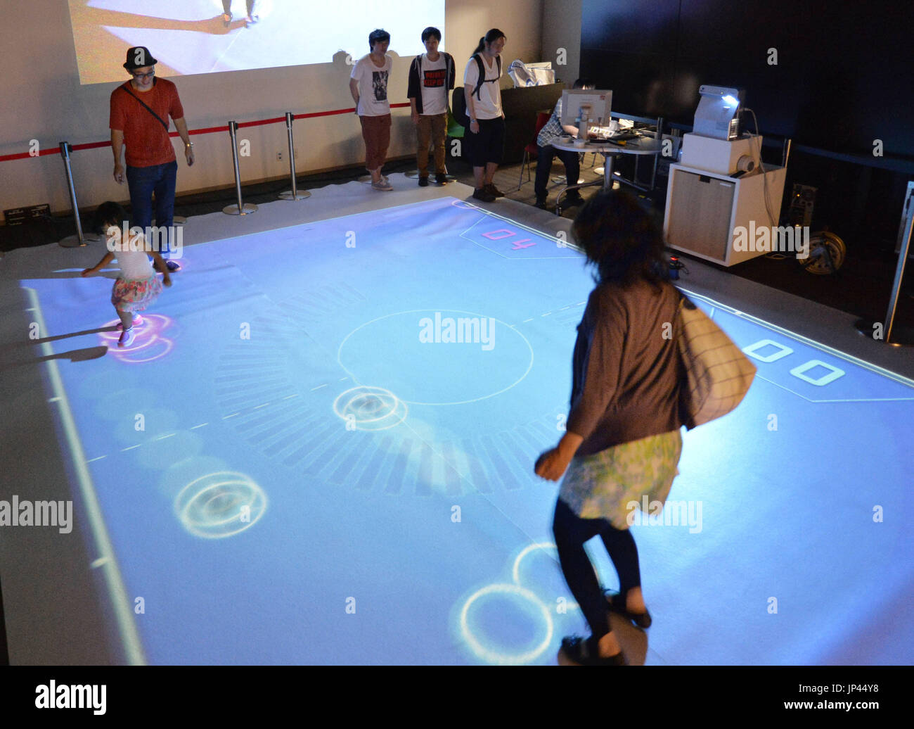 OSAKA, Japan - Visitors enjoy playing a virtual air hockey as if to ...