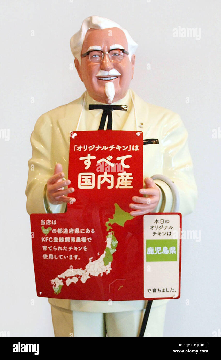 TOKYO, Japan - A statute of Colonel Sanders holds a poster in Tokyo on ...