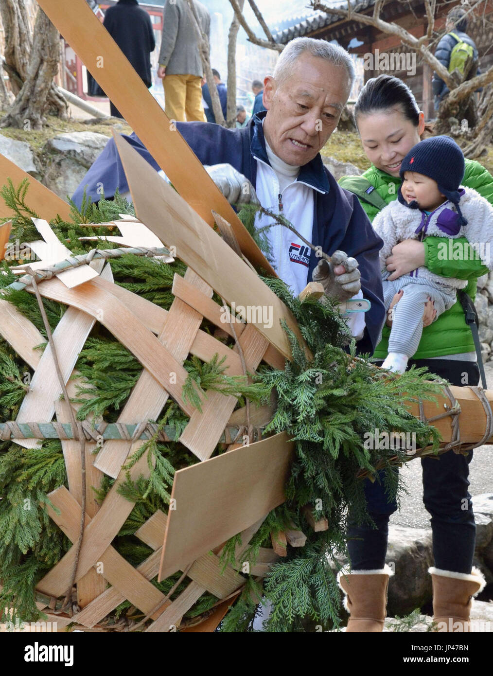 NARA, Japan - Teruo Nomura (L), 70, makes a gigantic "Kago taimatsu" torch, to be used in the ...