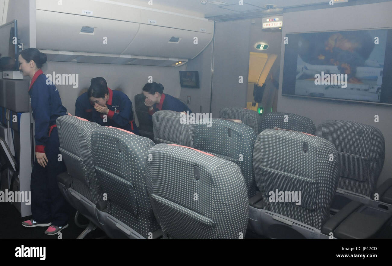 TOKYO, Japan - Members of Japan Airlines' cabin crew participate in an ...