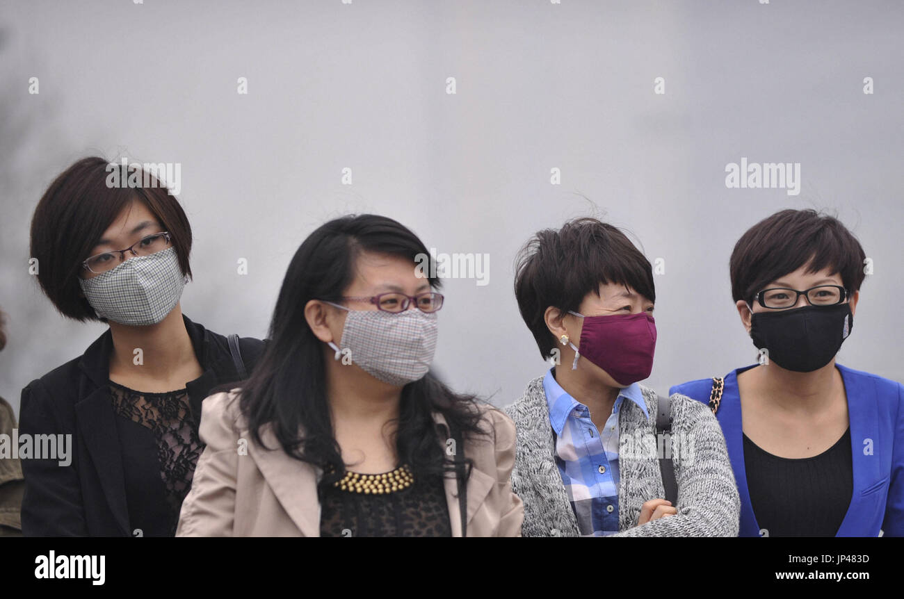 BEIJING, China - Women wear masks due to severe air pollution in ...