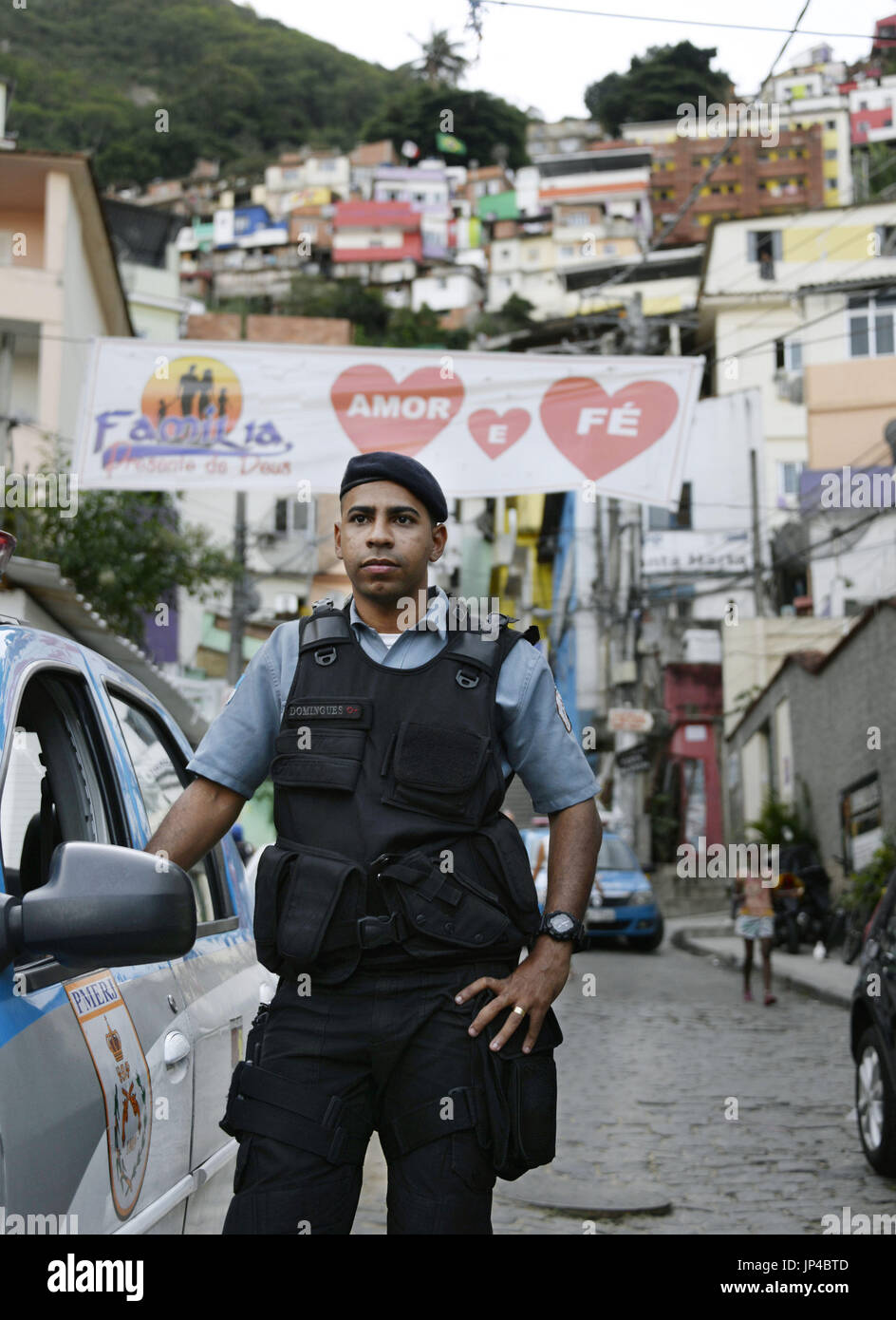 RIO DE JANEIRO, Brazil - A police officer patrols a "favela," or slum ...
