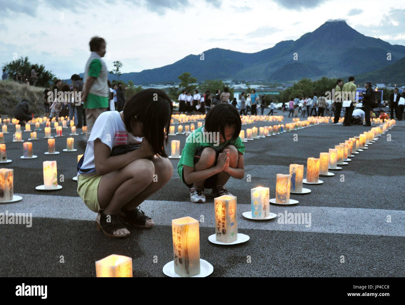SHIMABARA, Japan - Children offer prayers for the victims of a huge ...