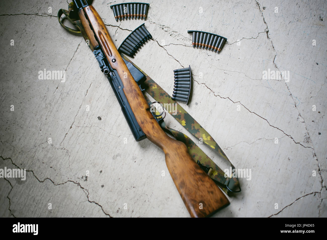 Rifle with cartridges on a textured concrete slab Stock Photo - Alamy