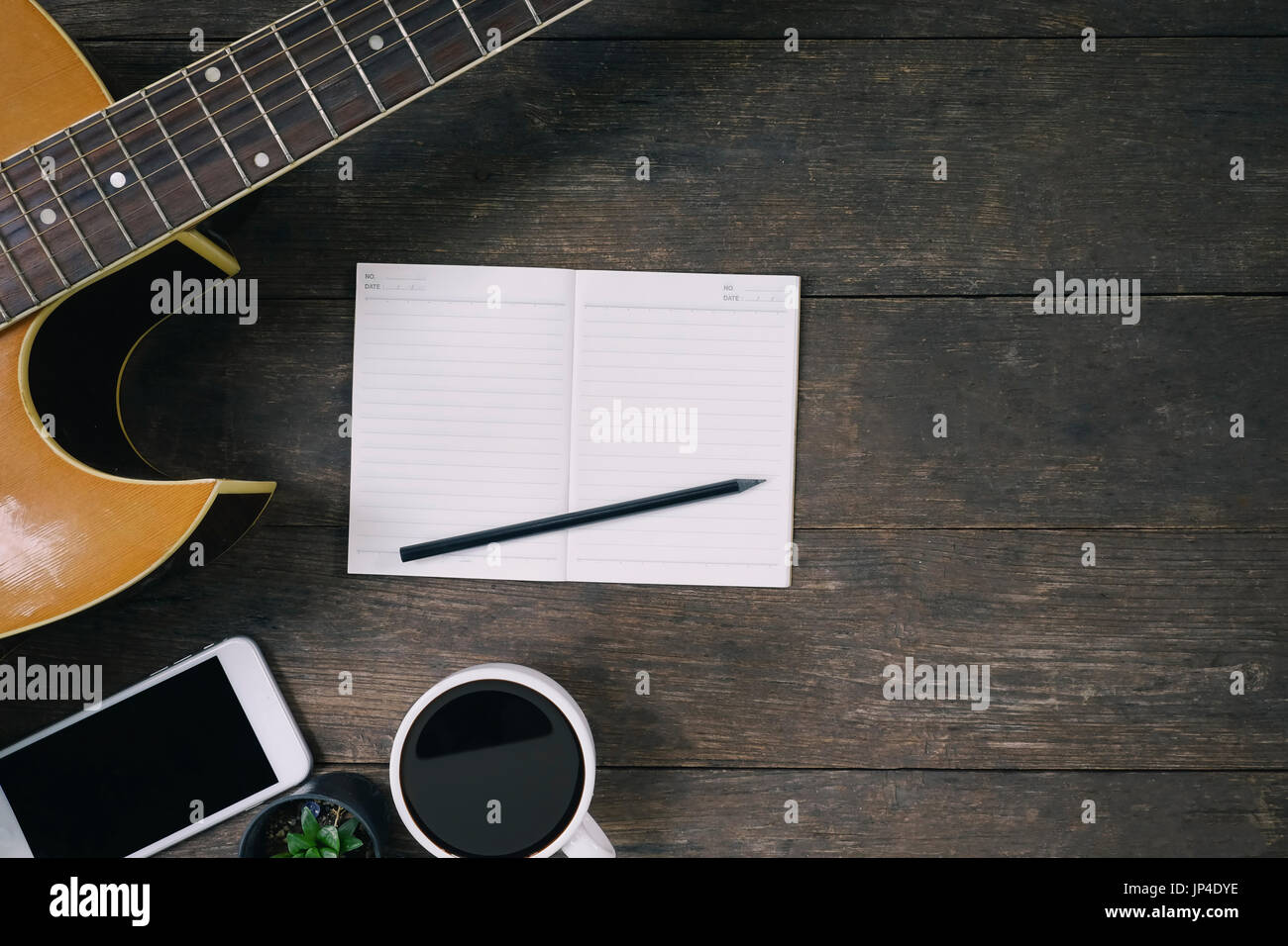 Desk of song composer for a work songwriter with a guitar and notepad ...