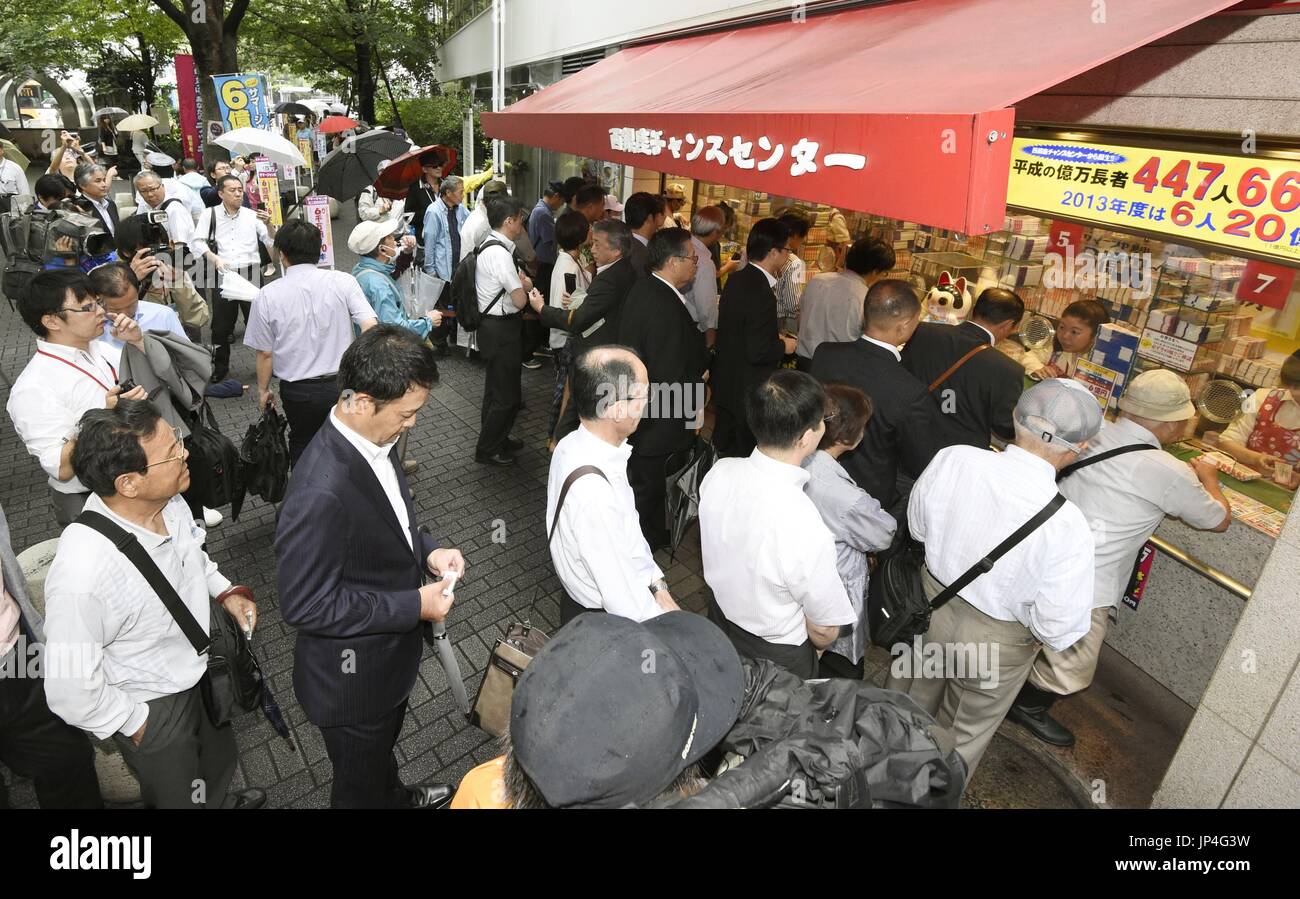 TOKYO, Japan - People line up in front of a lottery stand in Tokyo ...
