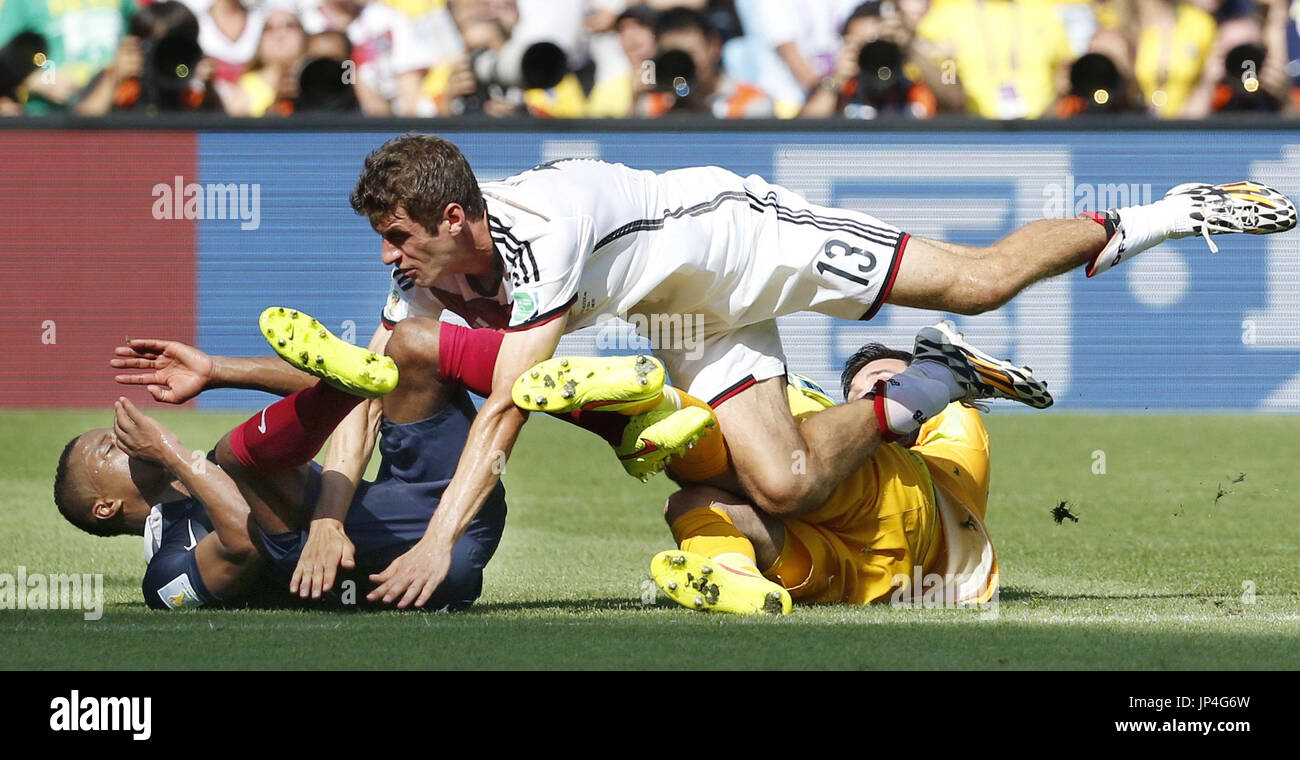 RIO DE JANEIRO, Brazil - Germany striker Thomas Muller (13) falls down ...