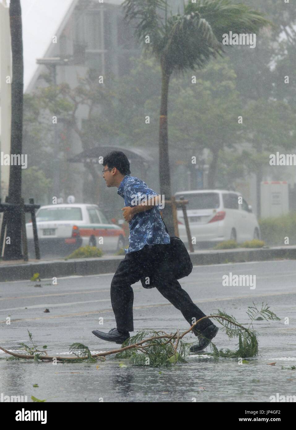 NAHA, Japan - A man walks over a pedestrian crossing in Naha, Okinawa ...