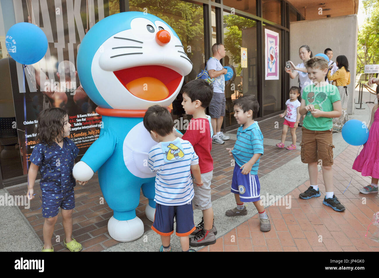 LOS ANGELES, United States - Children flock around an adult-size doll ...