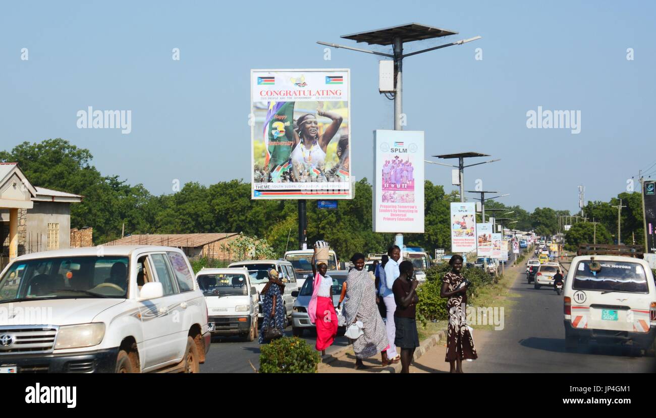 JUBA, South Sudan - People pass a street panel celebrating the third ...