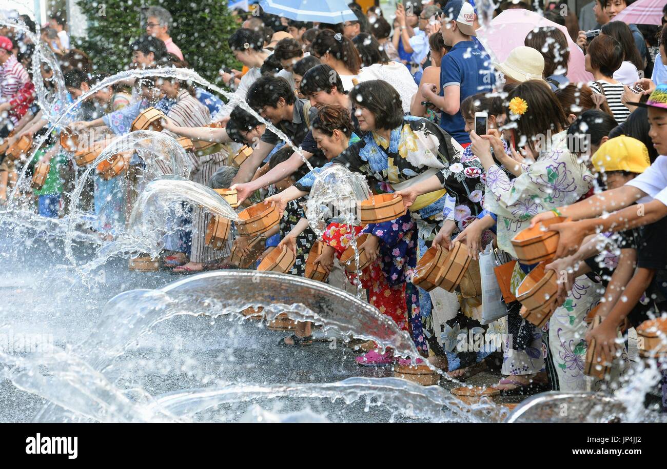 TOKYO, Japan - People wearing "yukata" Japanese summer kimono splash ...