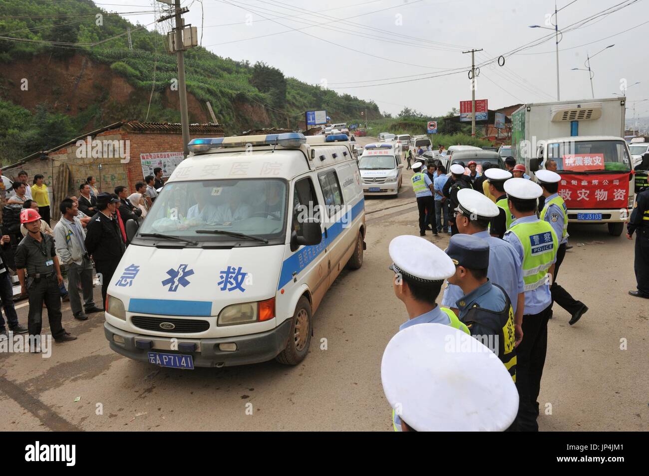 ZHAOTONG, China - Emergency vehicles head for the devastated area on ...