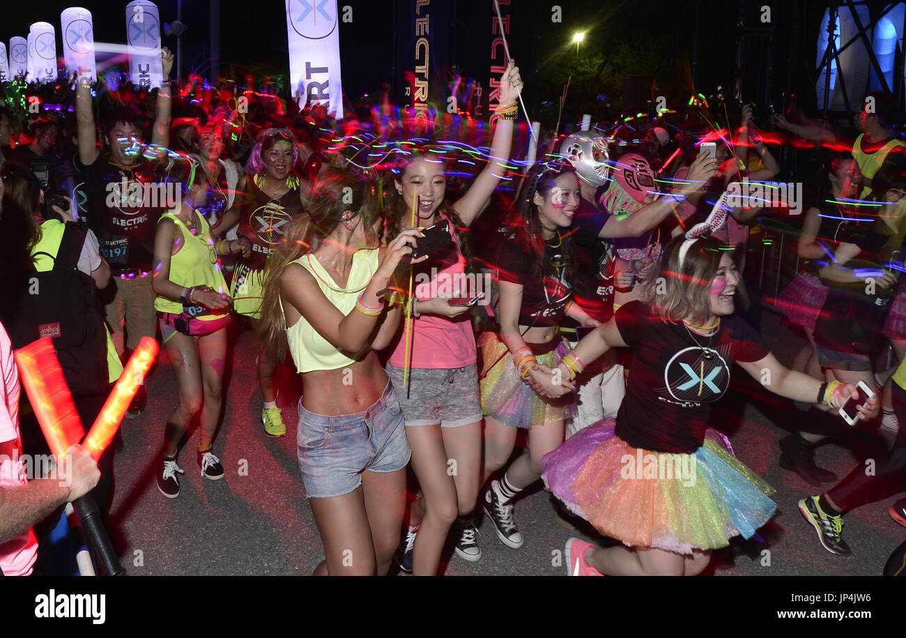 TOKYO, Japan - Participants start running in glowing costumes, some ...
