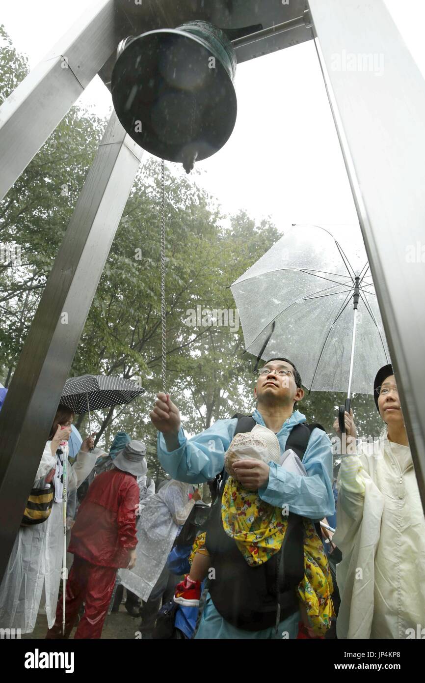 UENO, Japan - A mourner sounds a bell at Osutaka Ridge, the accident ...