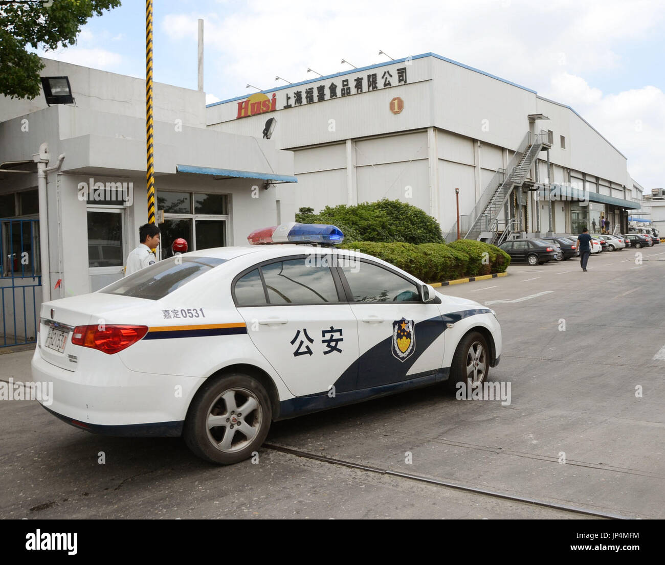 SHANGHAI, China - A police car enters meat processor Shanghai Husi Food ...