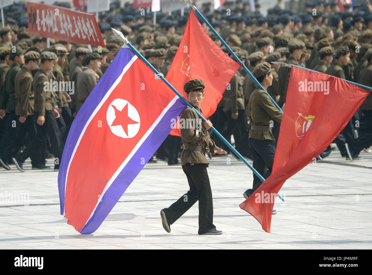 PYONGYANG, North Korea - A man carries the North Korean flag at Kim Il ...
