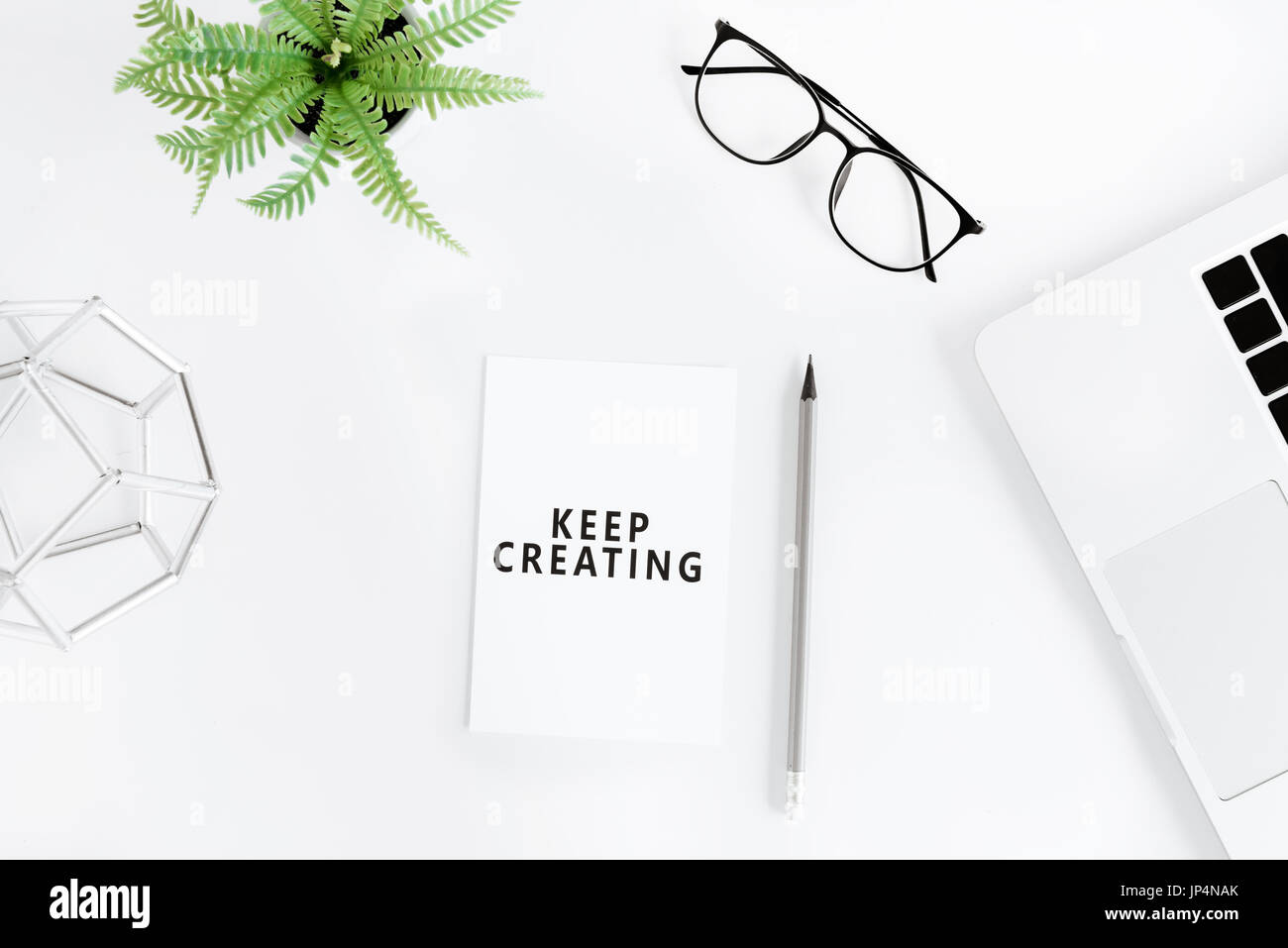 flat lay with Keep creating motivational quote on modern workplace with ...