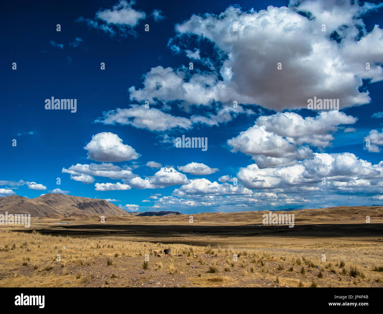 Blue sky with clouds in the roads of Puno, Peru Stock Photo - Alamy