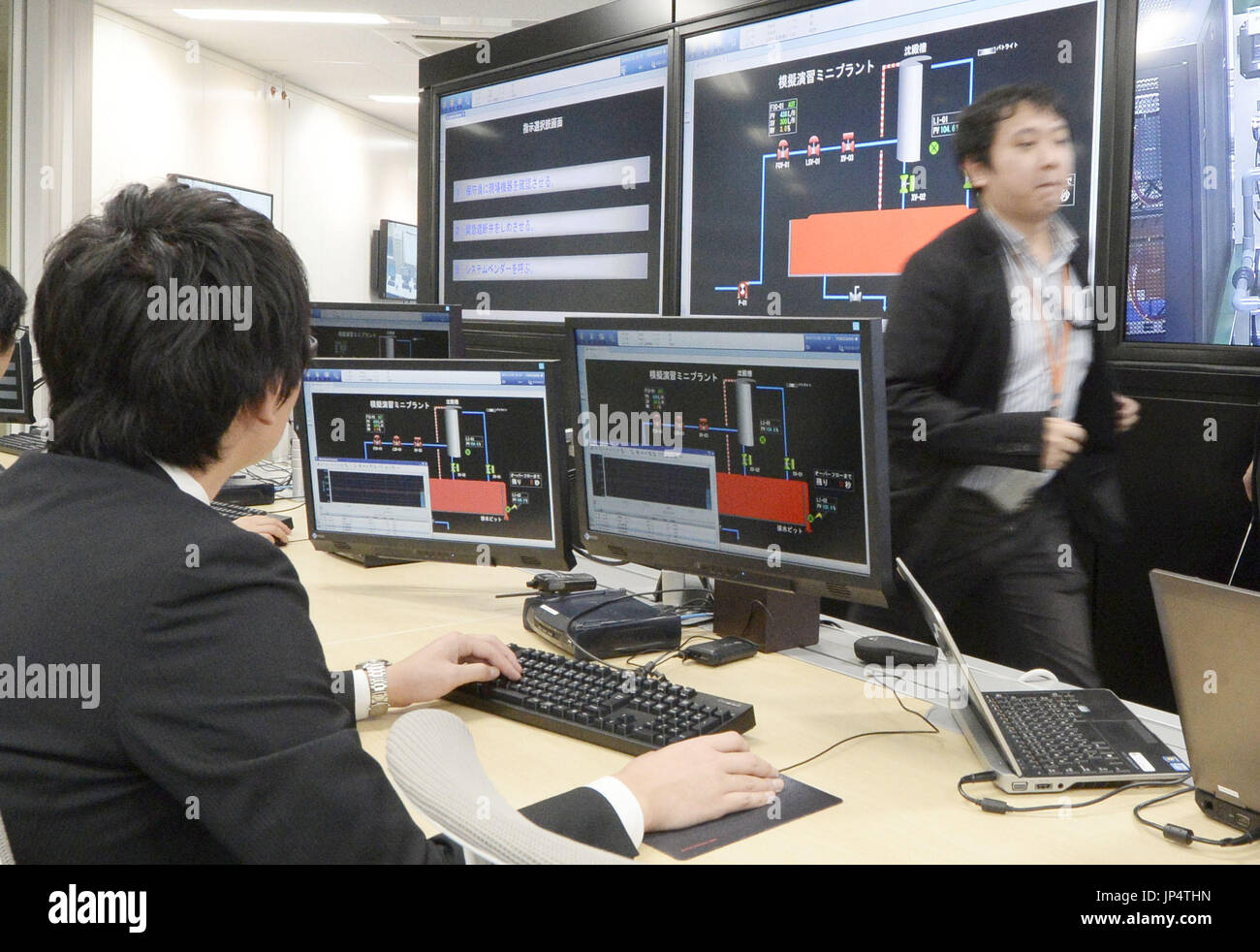 TOKYO, Japan - Staff members at the Control System Security Center ...