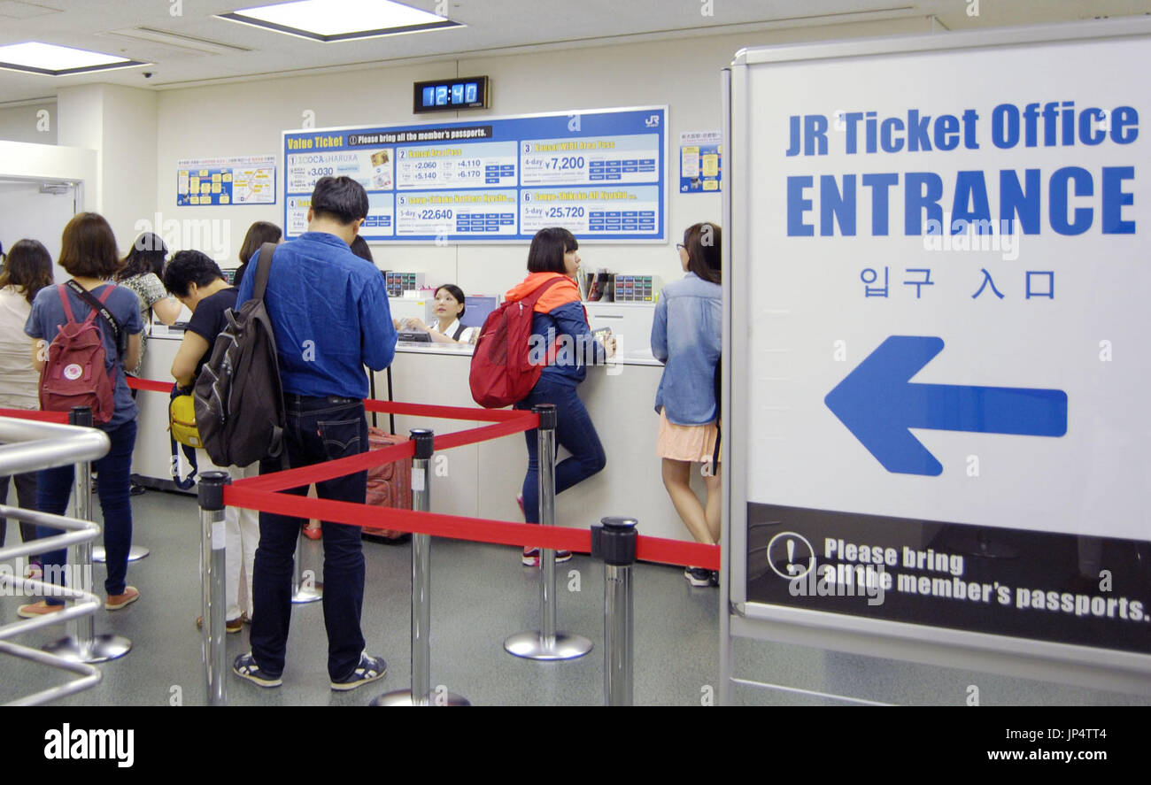 OSAKA, Japan - Passengers line up at ticket counters newly set up ...