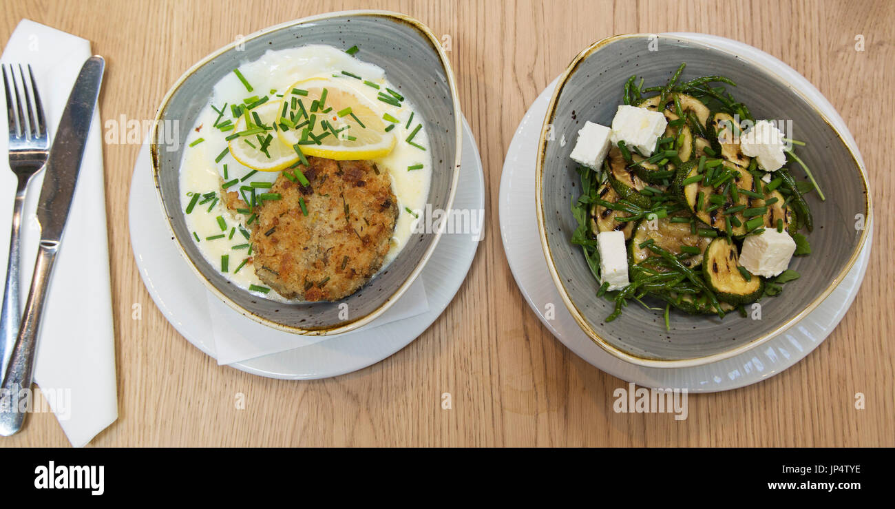 Fish cakes served with a fried egg plus samphire and courgette salad ...