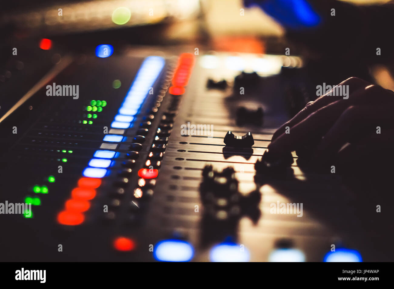 The hands of the sound engineer on the mixing console Stock Photo - Alamy