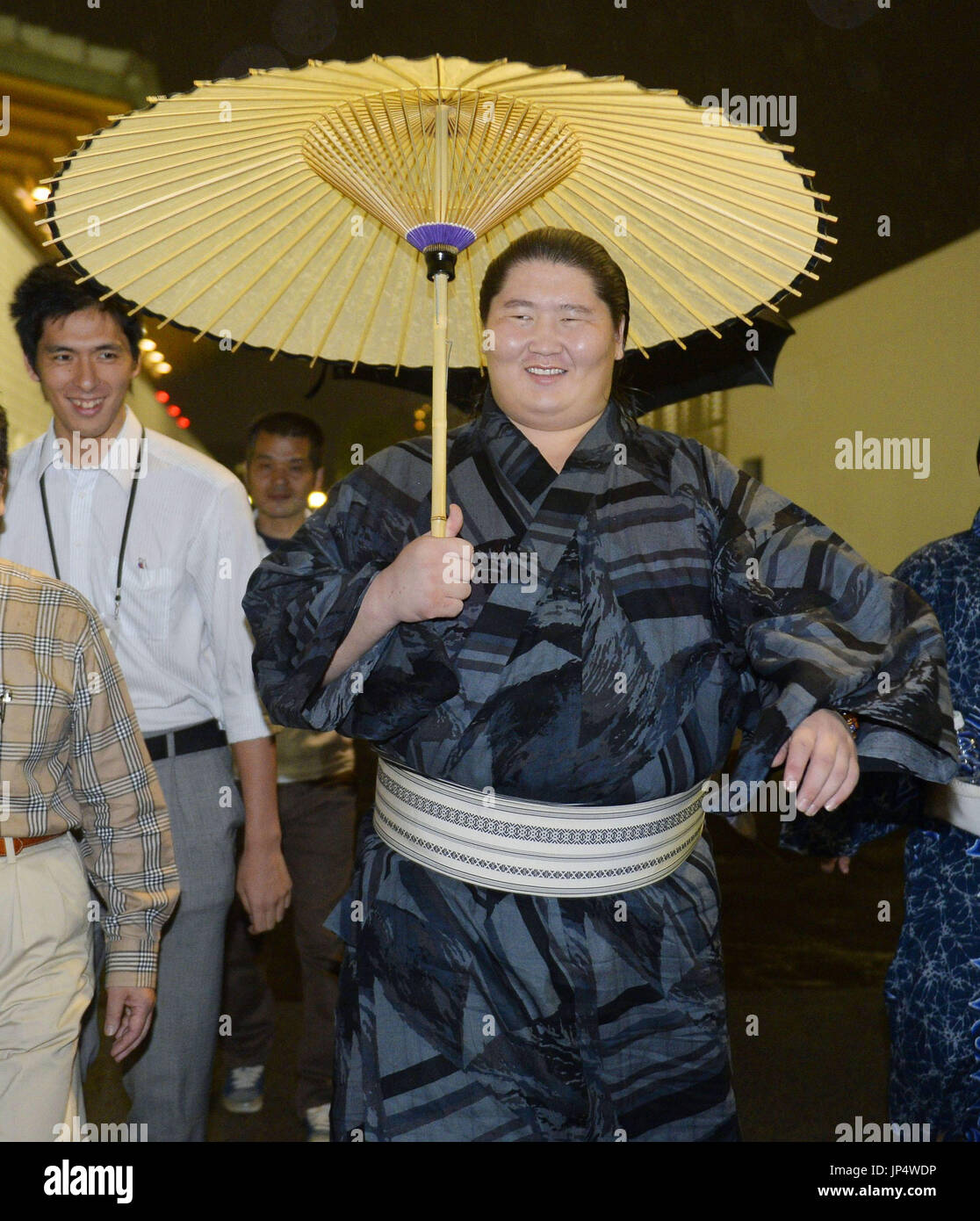 TOKYO, Japan - Ichinojo, a 10th-ranked maegashira, smiles as he leaves ...