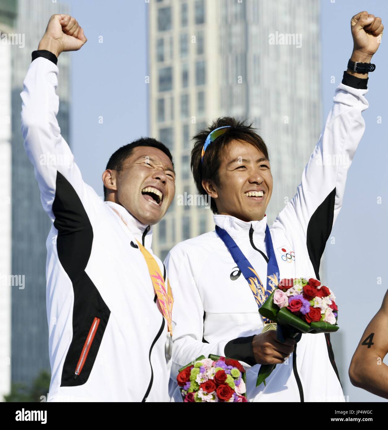 INCHEON, South Korea - Japan's Yuichi Hosoda (R) and Hirokatsu Tayama celebrate during an award ...
