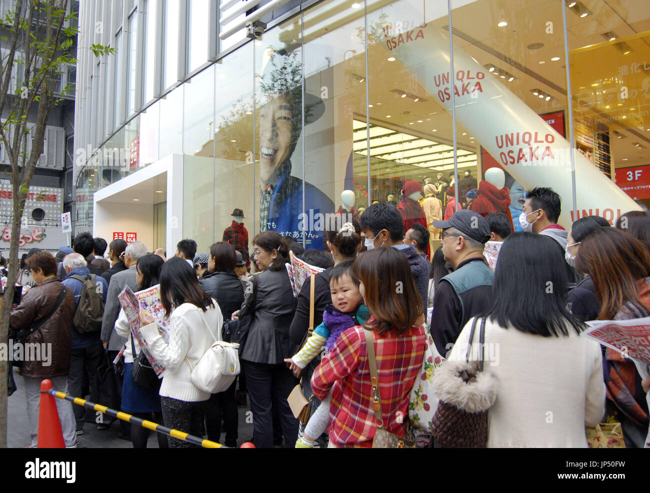 OSAKA, Japan - Customers queue outside the second Osaka flagship store ...