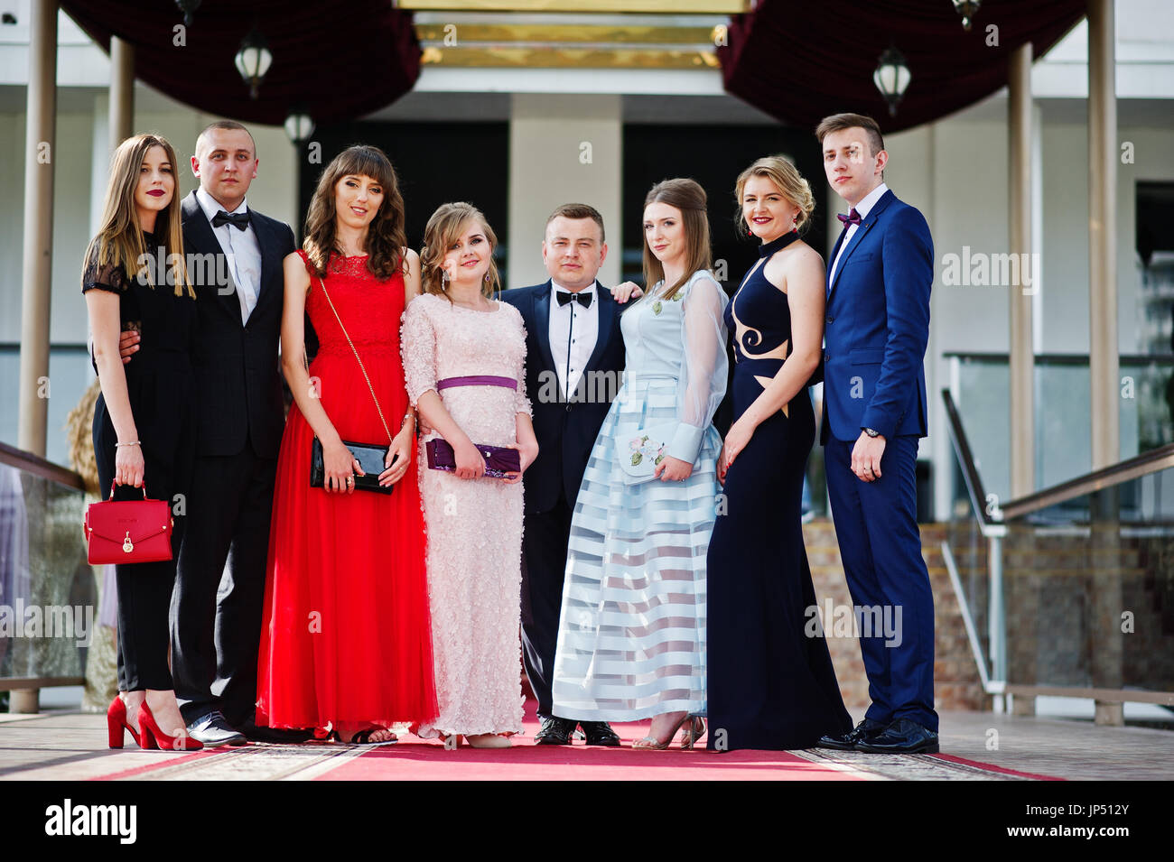 Group of good-looking graduates posing on the graduation day next to ...