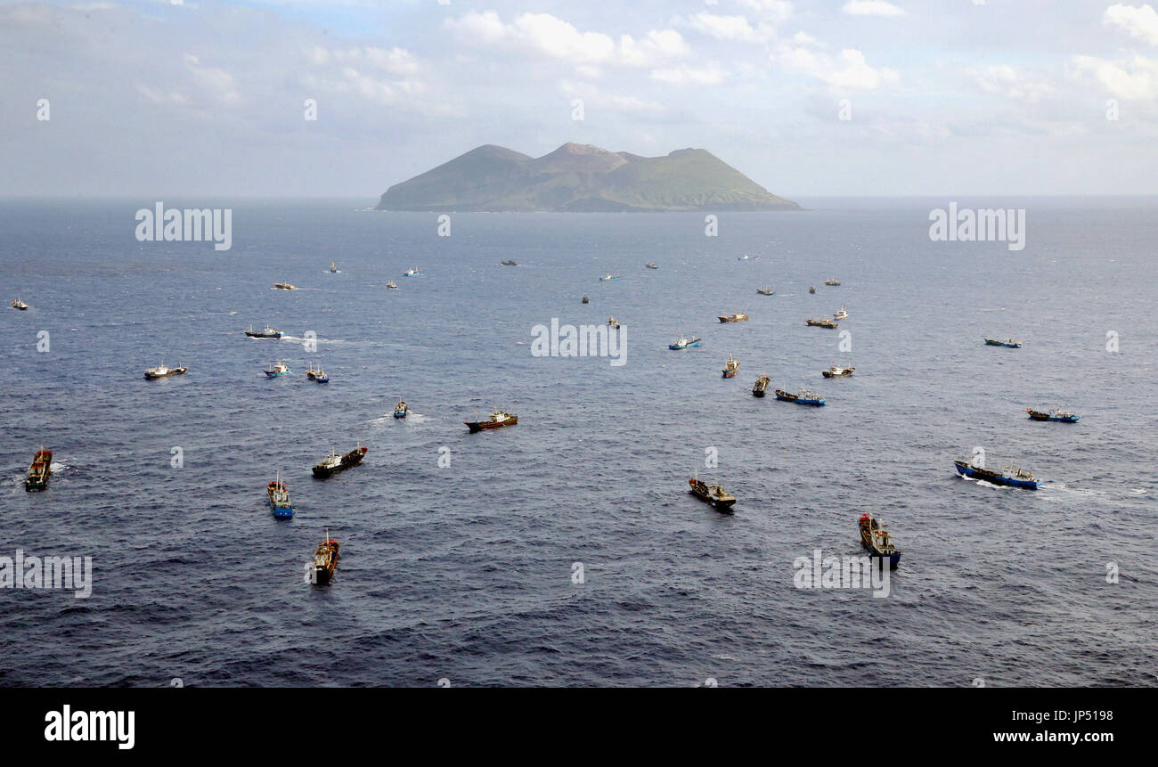 TOKYO, Japan - Foreign fishing boats operate near Tori Island (back) in ...