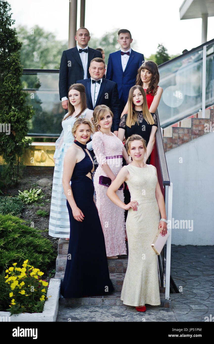 Group of good-looking graduates posing on the graduation day next to ...